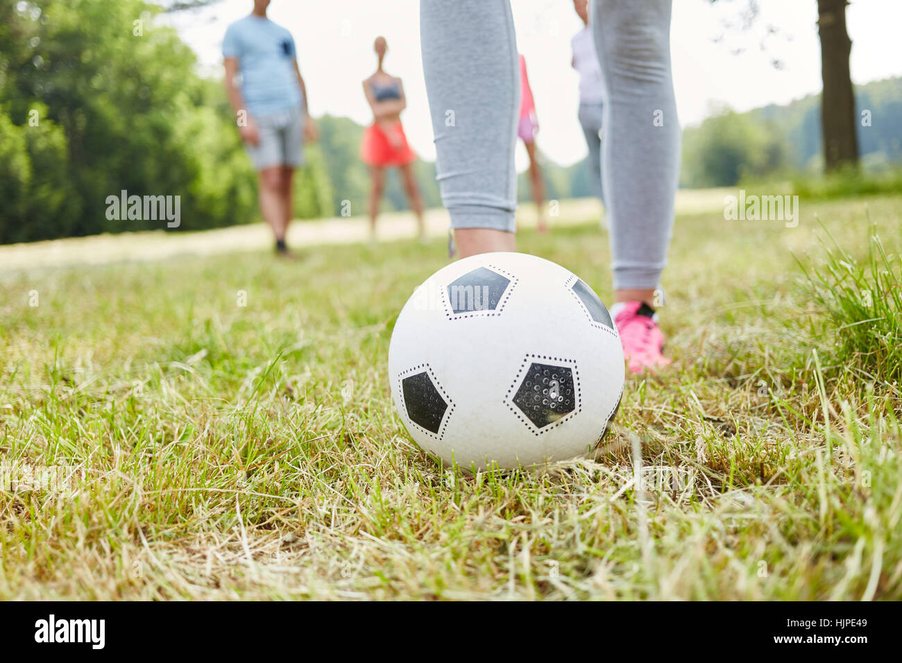 Friends playing soccer in the park in their leisure time Stock Photo ...