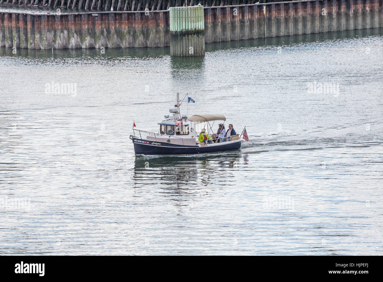 Four People in Small Cabin Cruiser Stock Photo - Alamy