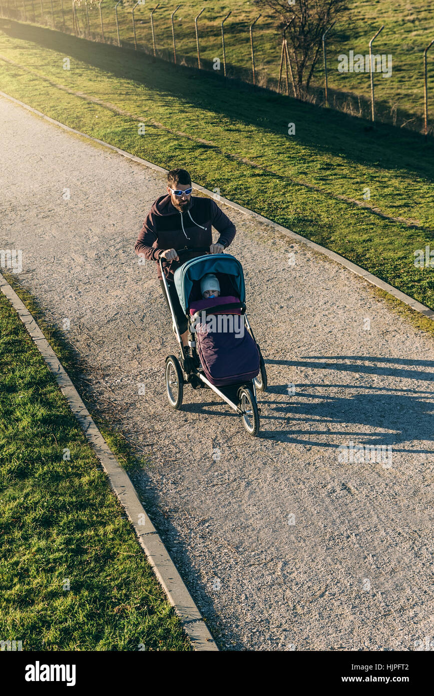 Father and son running in the park. Family and sport concept Stock ...