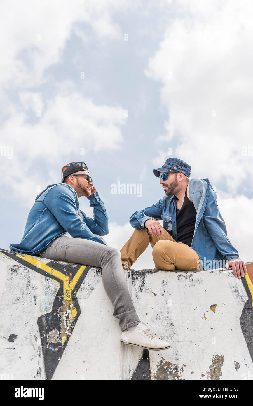 Taking the time to talk to your friend . Two handsome young men talking ...