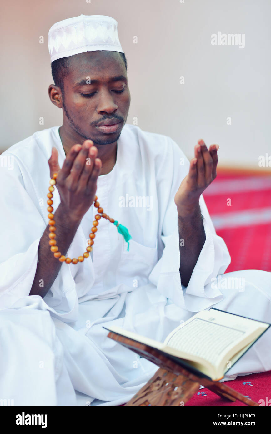 African Muslim Man Making Traditional Prayer To God While Wearing ...