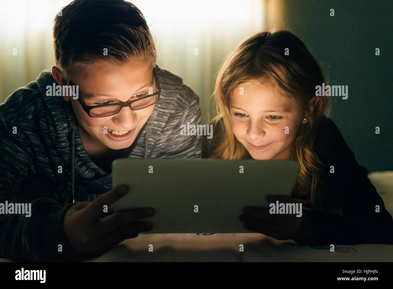 Two sweet kids playing on a Tablet PC. Family Concept Stock Photo - Alamy