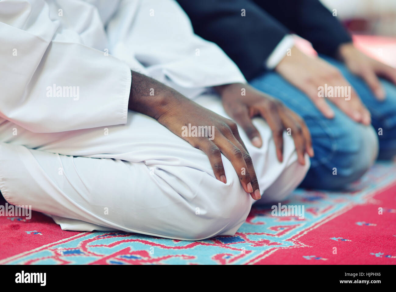 Two religious muslim man praying together inside the mosque Stock Photo ...