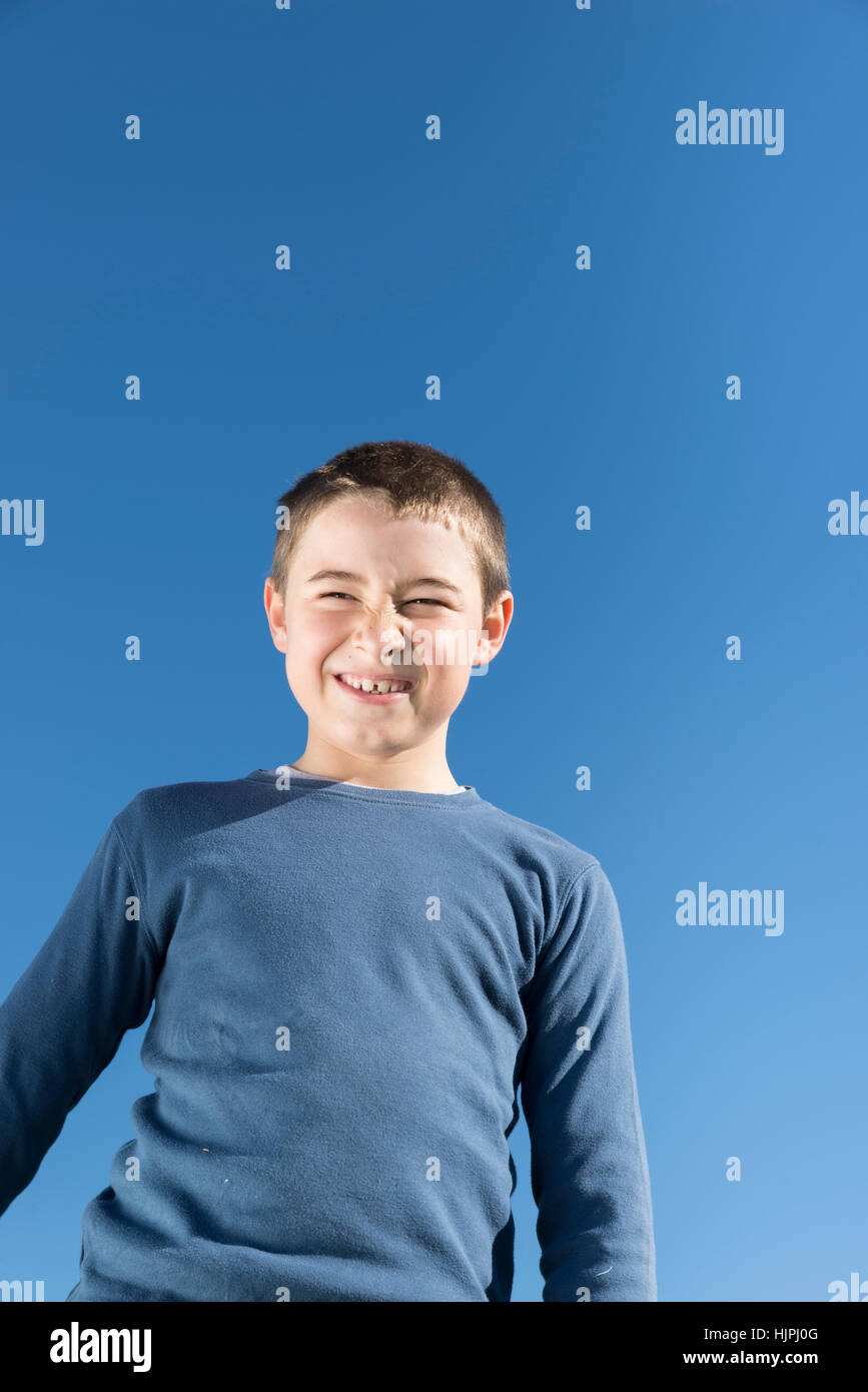 sad angry boy looking at camera in the park Stock Photo - Alamy
