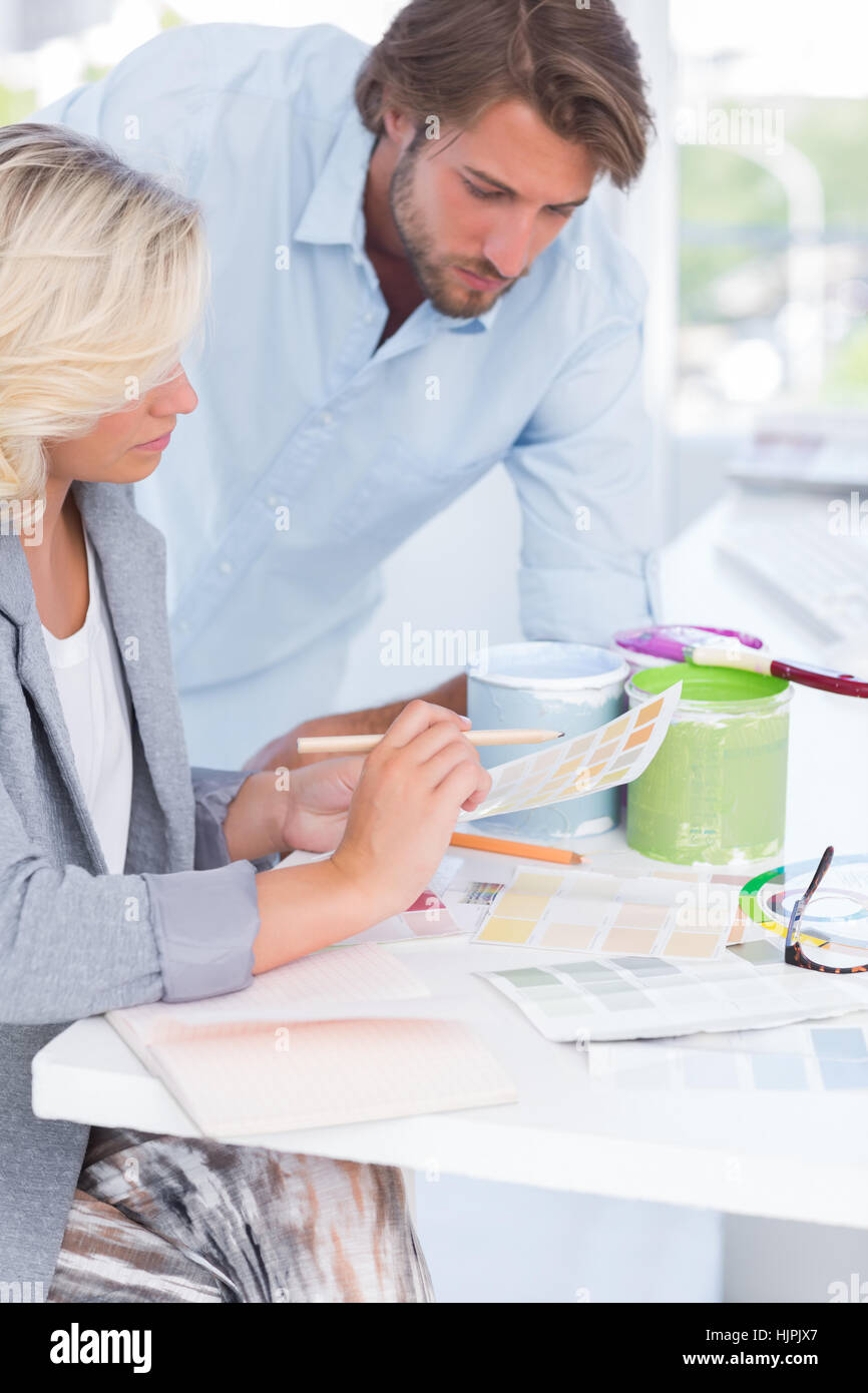 Two colleagues of interior design working together on colour charts in ...
