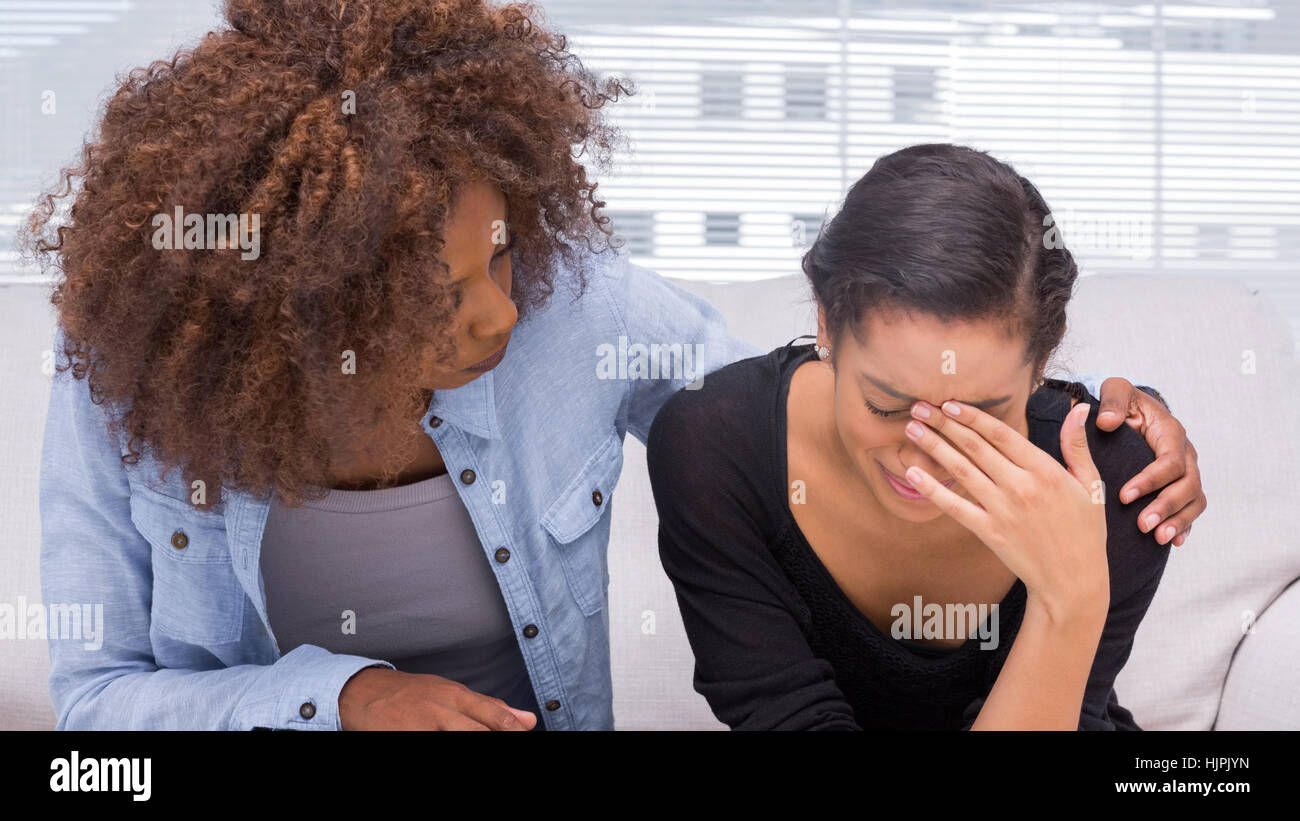 Female psychiatrist comforting young crying hi-res stock photography ...