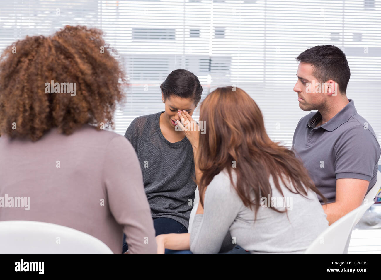 Patient crying during group therapy session Stock Photo - Alamy