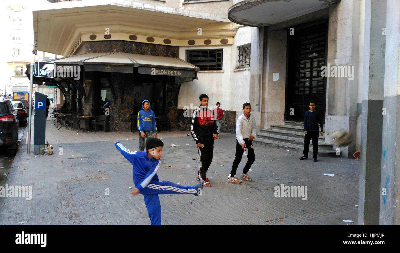 Kids playing football in street hi-res stock photography and images - Alamy