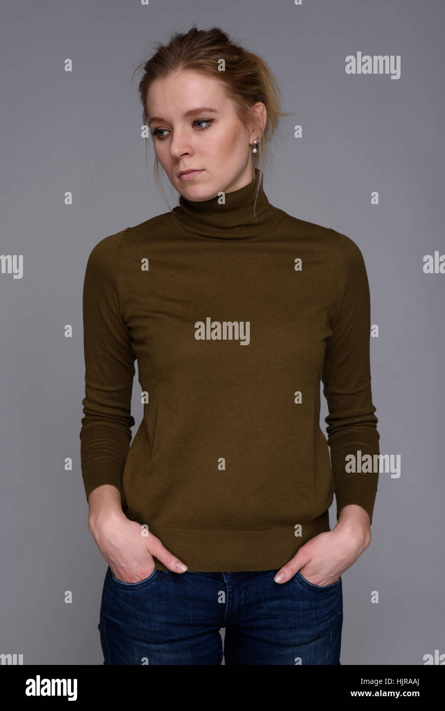 sad pretty girl looking down. Isolated on grey background Stock Photo ...