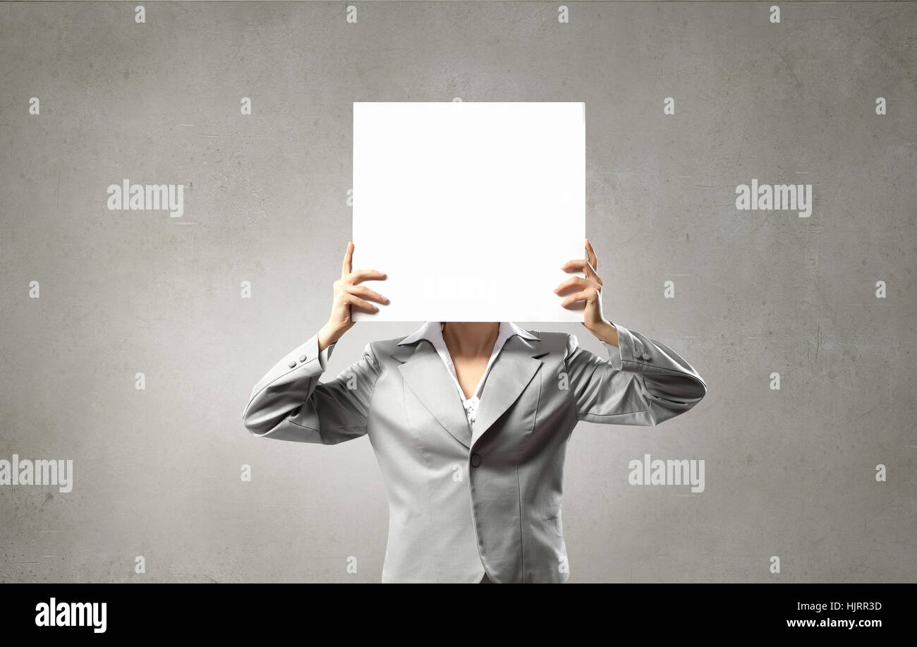 Businesswoman hiding her face behind paper list hi-res stock ...