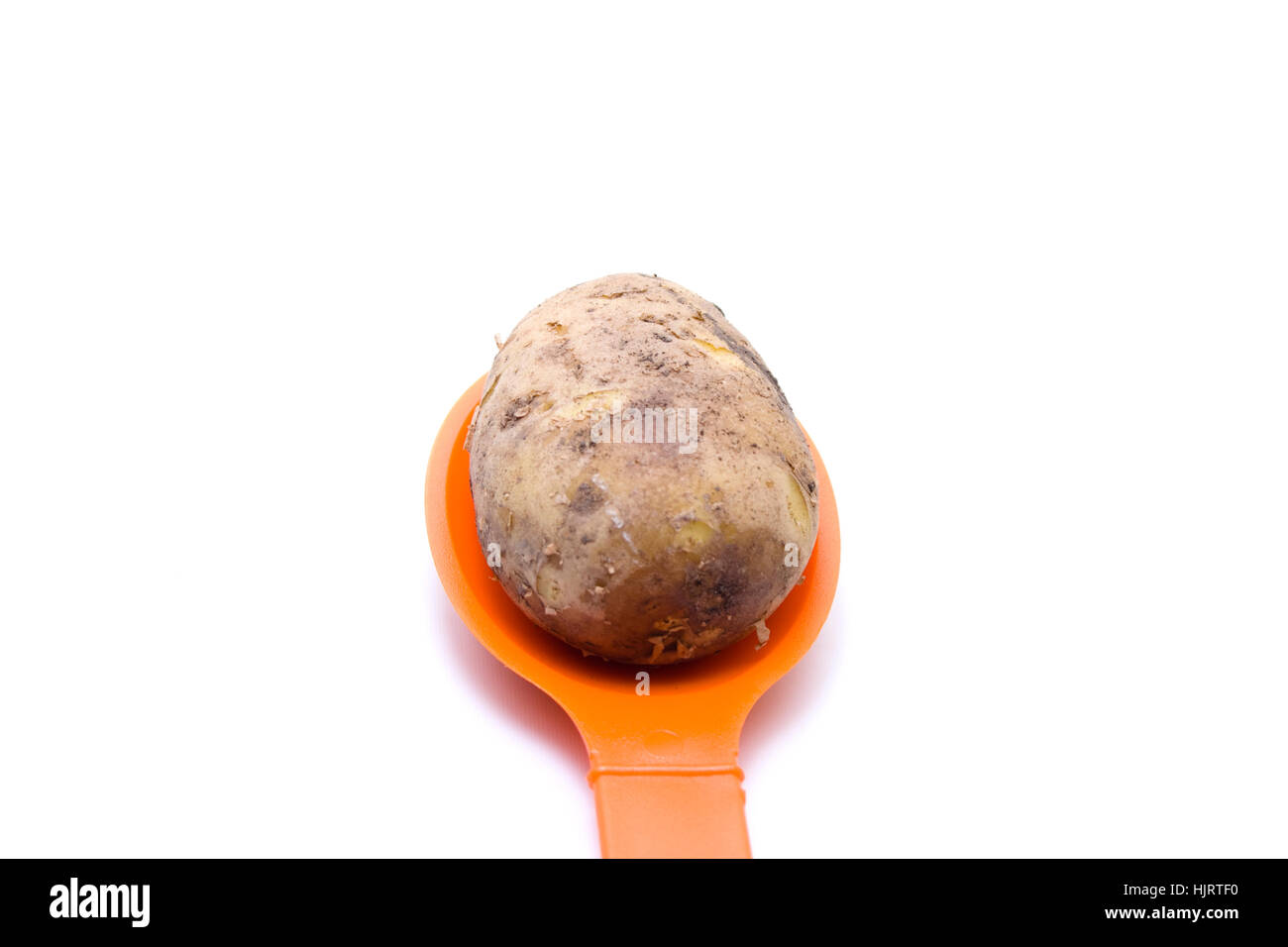 fresh potato on plastic spoon Stock Photo - Alamy