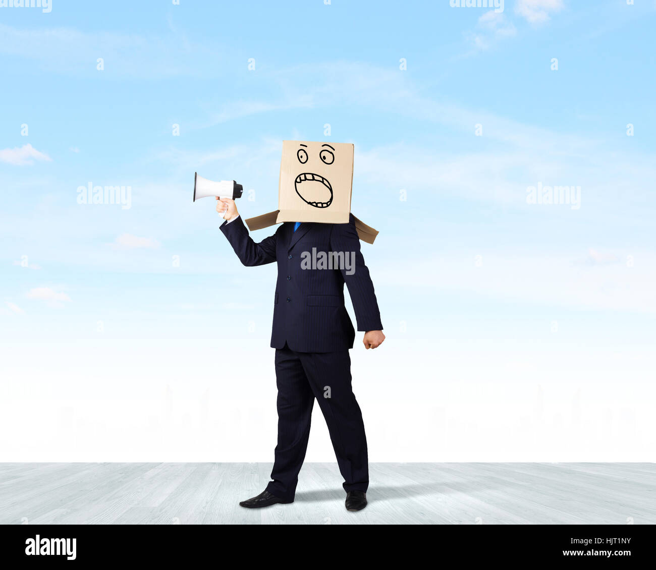 Businessman wearing box on head screaming in to megaphone hi-res stock ...