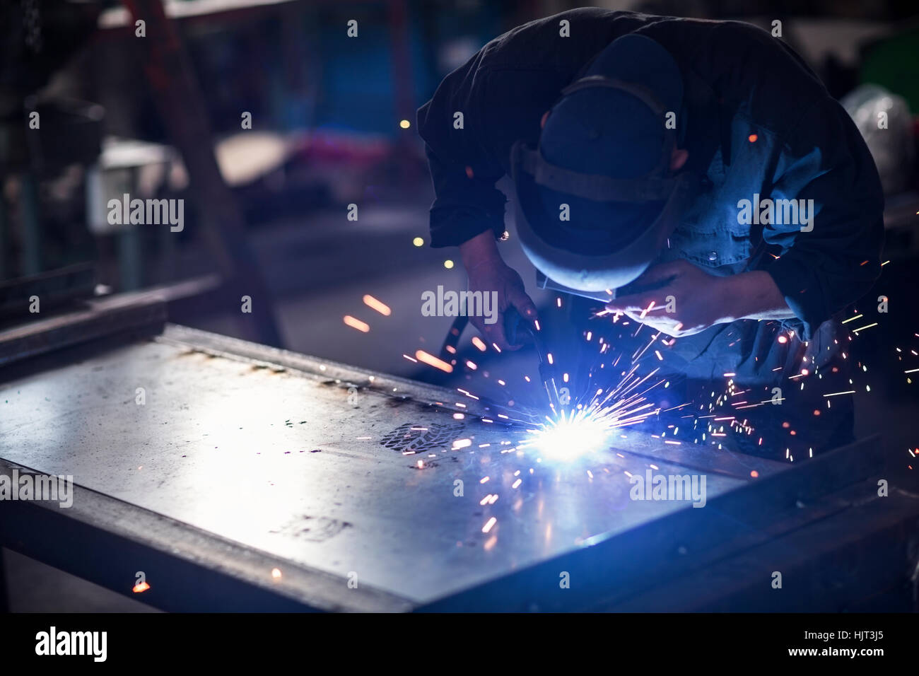 Welder at work in workshop Stock Photo - Alamy