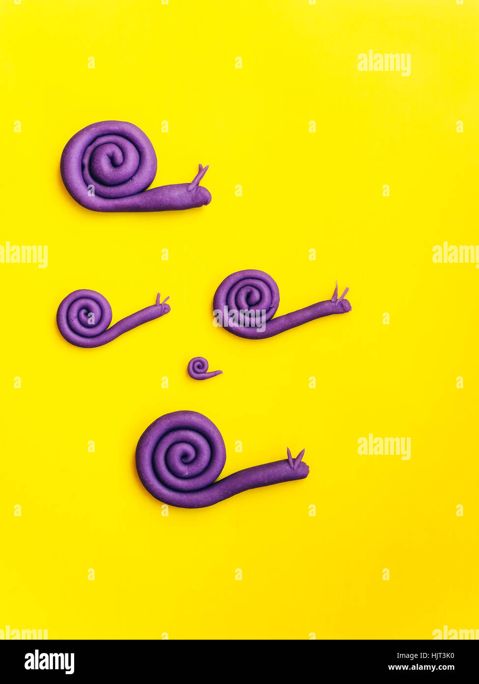 Snail family made of modelling clay on yellow background Stock Photo ...