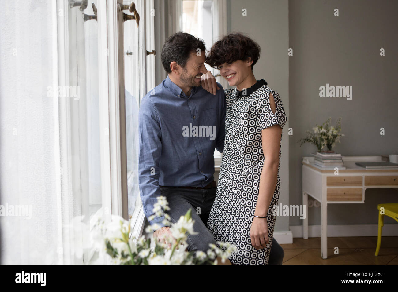 Laughing couple at home Stock Photo - Alamy