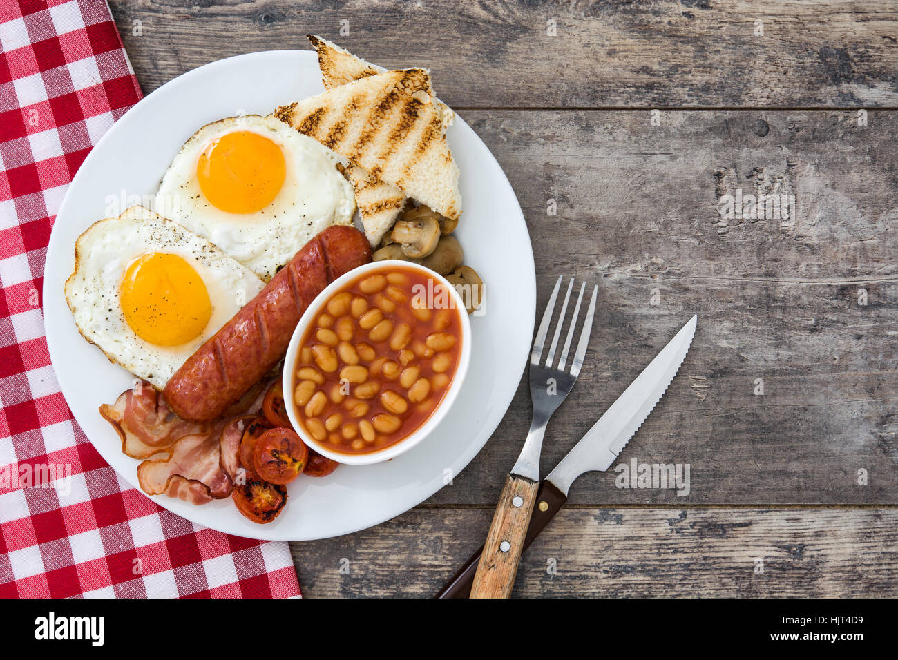 Traditional full English breakfast with fried eggs, sausages, beans ...