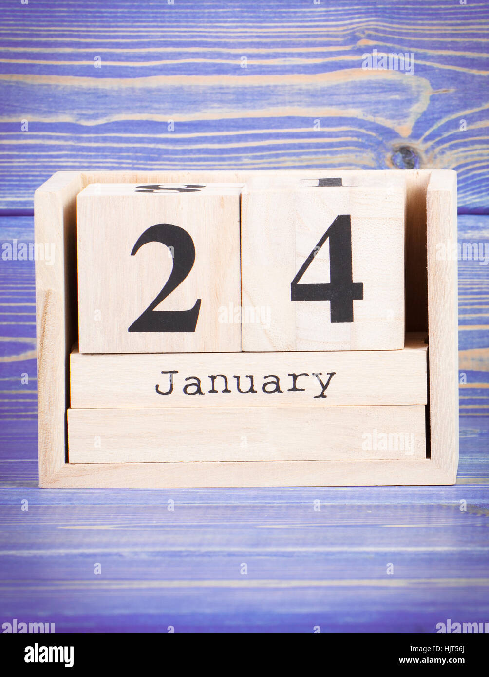 January 24th. Date of 24 January on wooden cube calendar, purple board ...