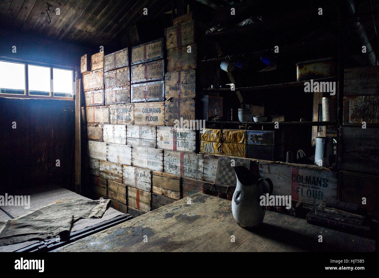 Timber food boxes used to build a makeshift wall in the hut of ...