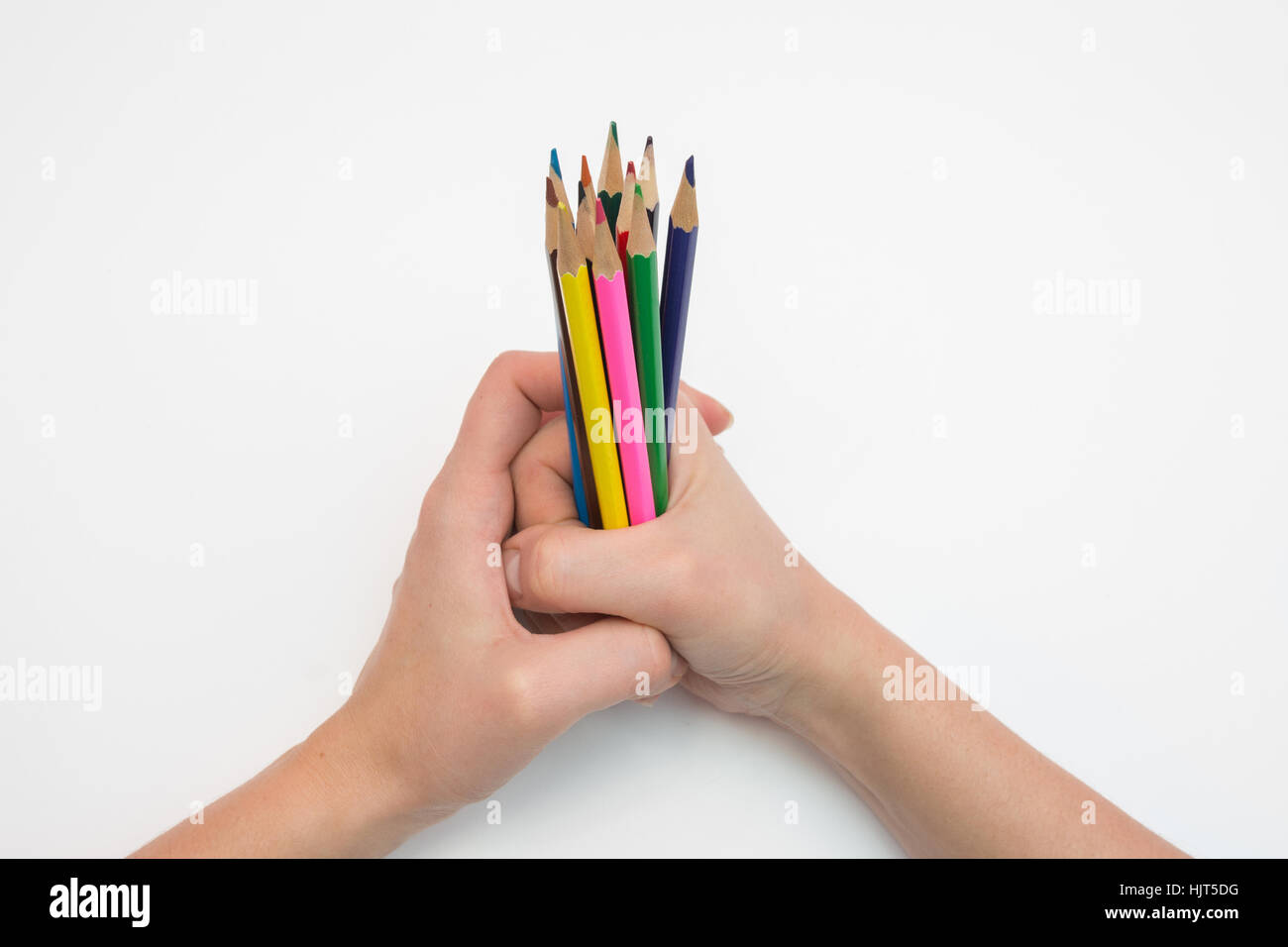 Female hand clenched in a fist dozen pencils Stock Photo - Alamy