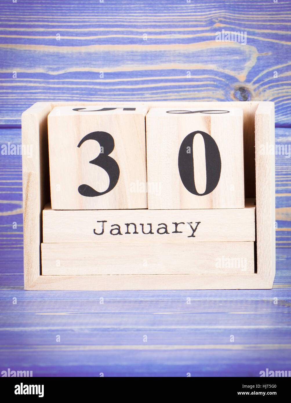 January 30th. Date of 30 January on wooden cube calendar, purple board ...
