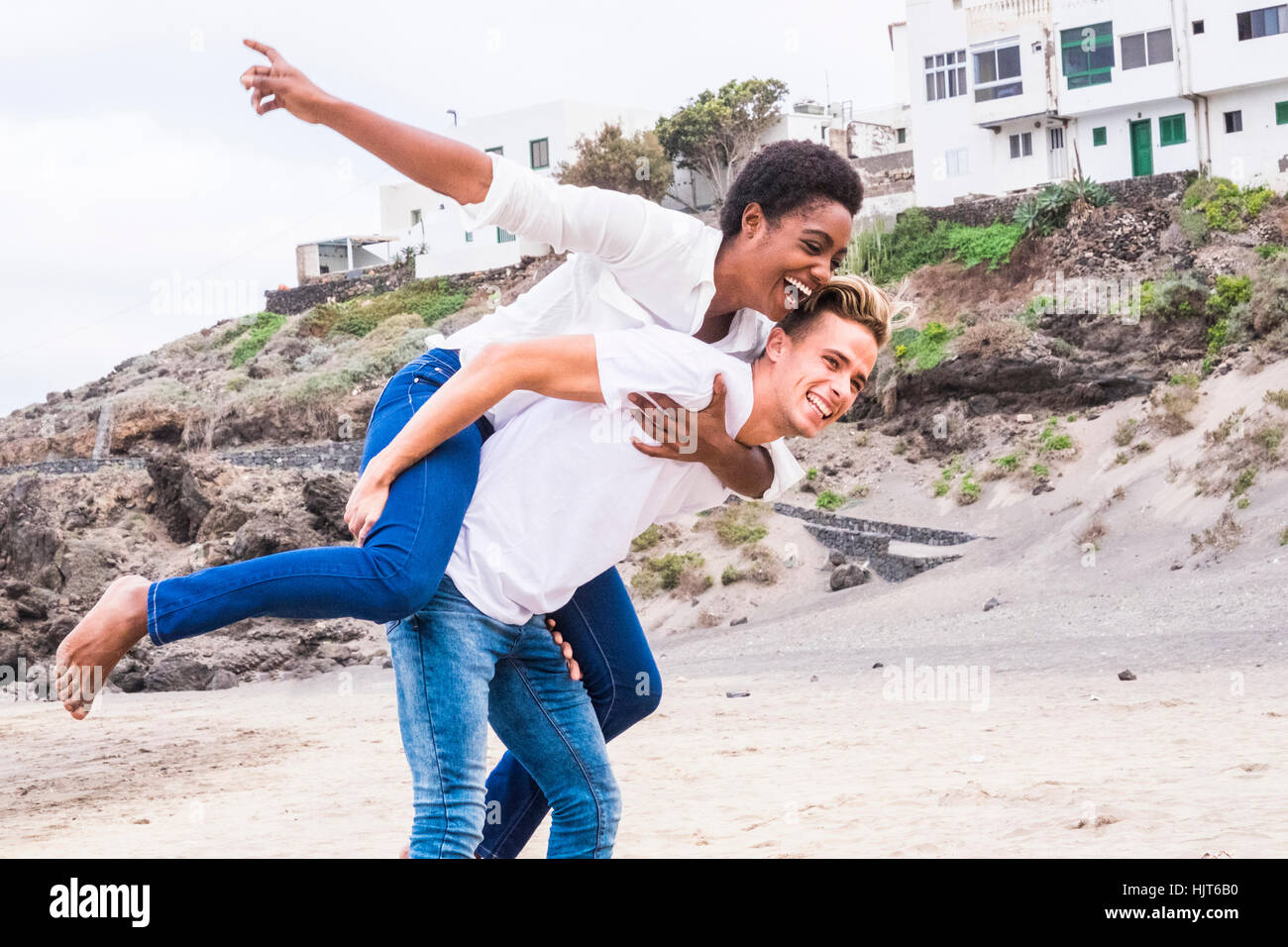 Young couple pretending to fly on a beach Stock Photo - Alamy
