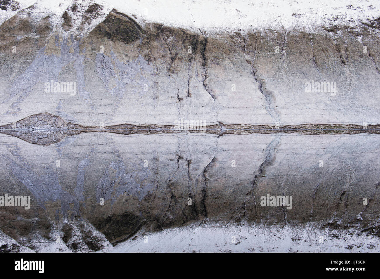 Mountainside rock and frost with reflections on Talla reservoir ...