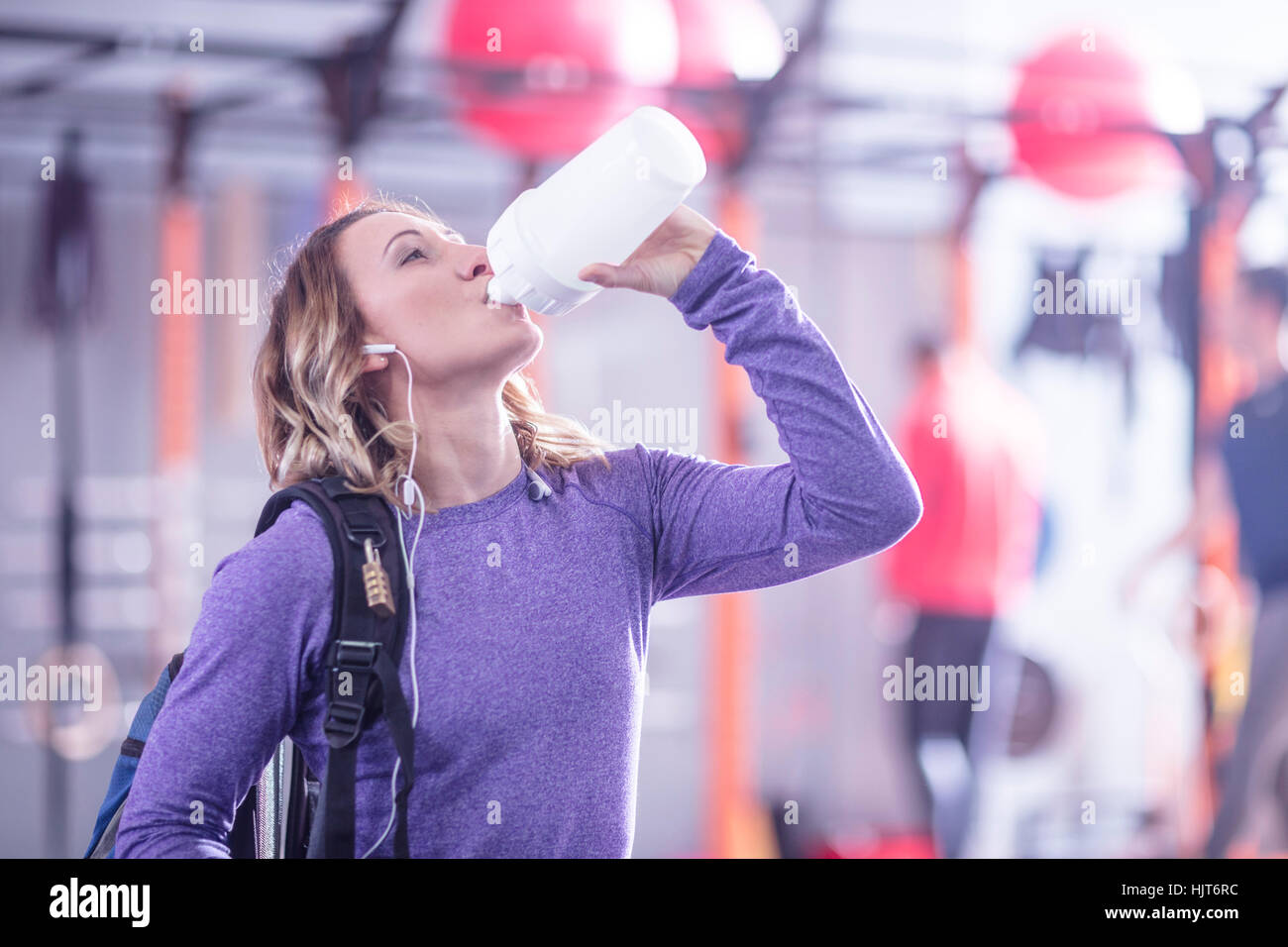 Young woman taking a refreshment break in gym Stock Photo - Alamy
