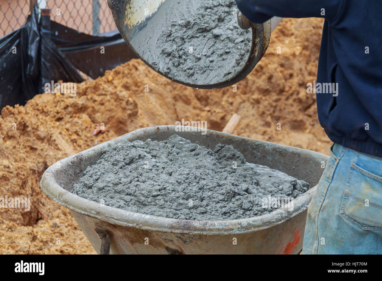 pouring wet cement to cart at construction site Stock Photo - Alamy
