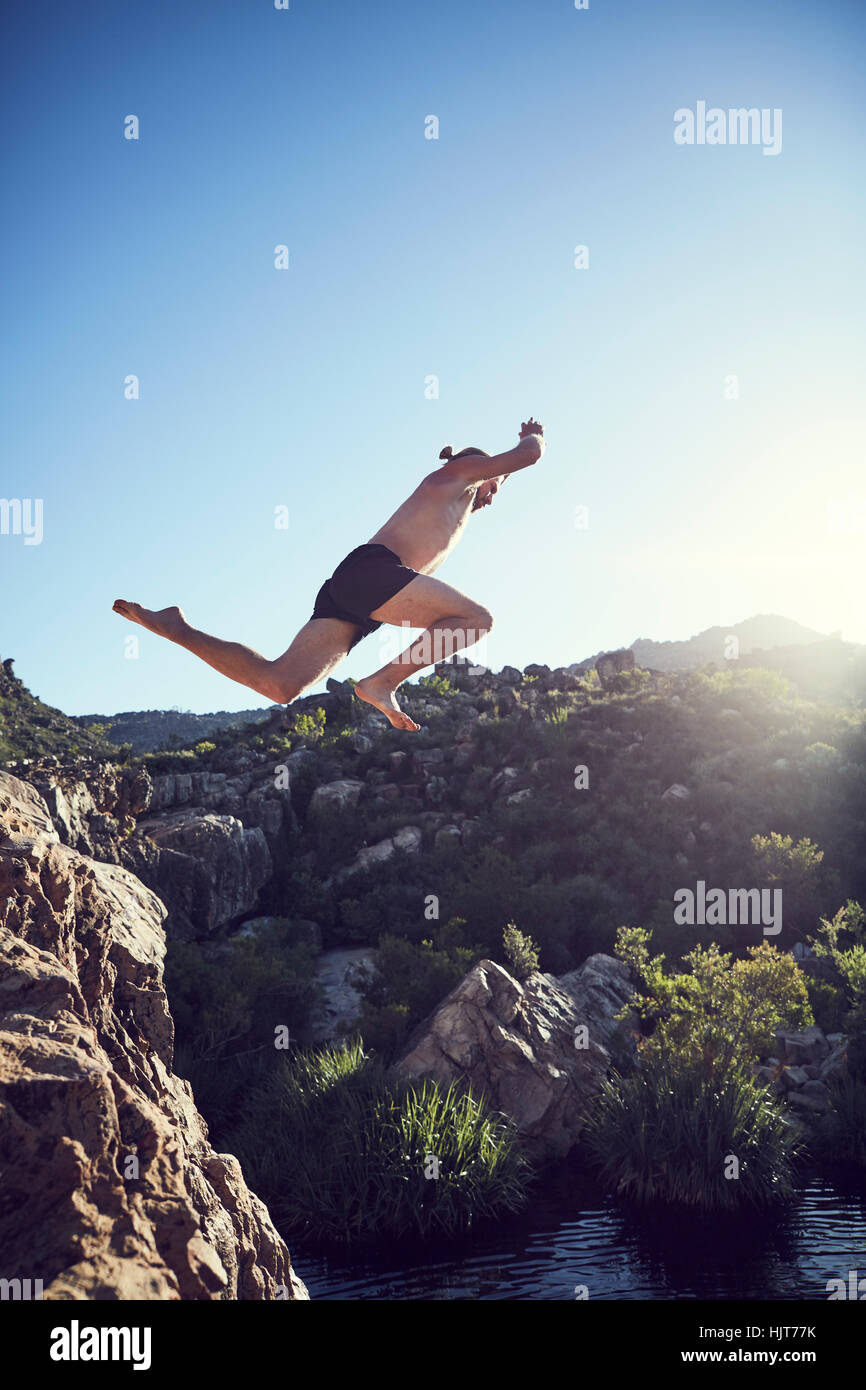 South Africa, Porterville, Beaverlac, man jumping from rock into water ...