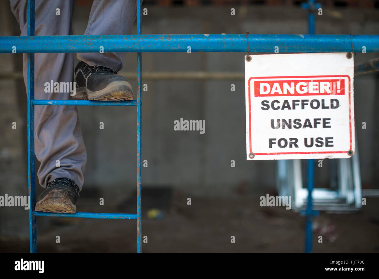 Construction worker climbing scaffold ladder Stock Photo - Alamy