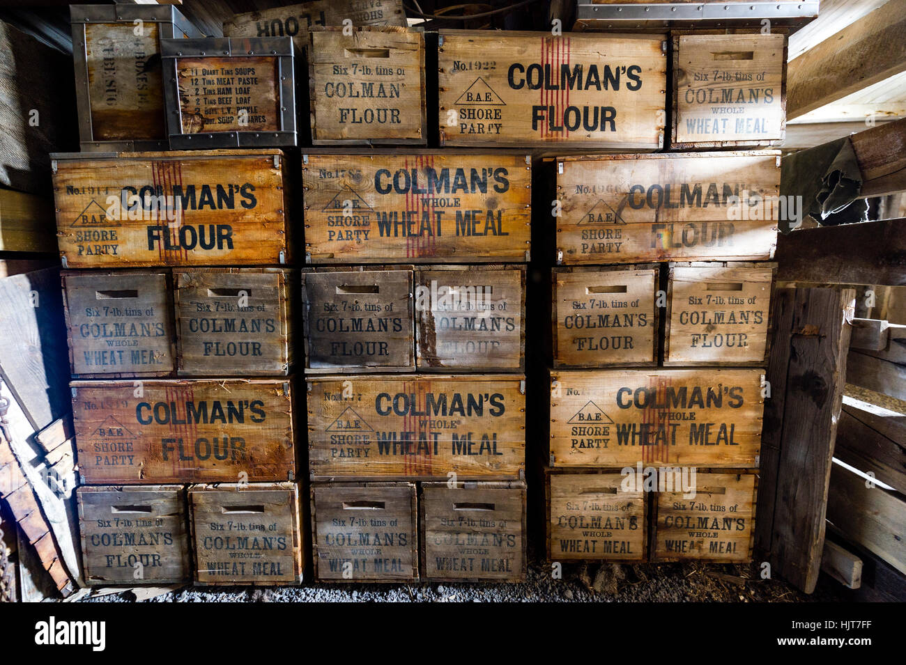 Timber food boxes used to build a makeshift wall in the hut of ...
