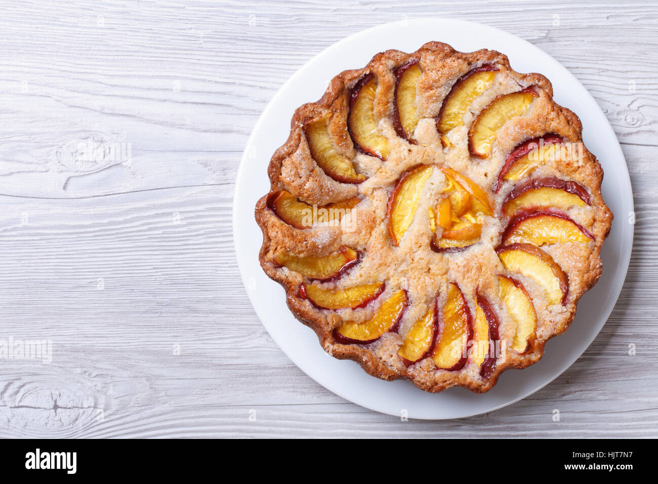 round peach pie on a wooden background horizontal view from above Stock ...