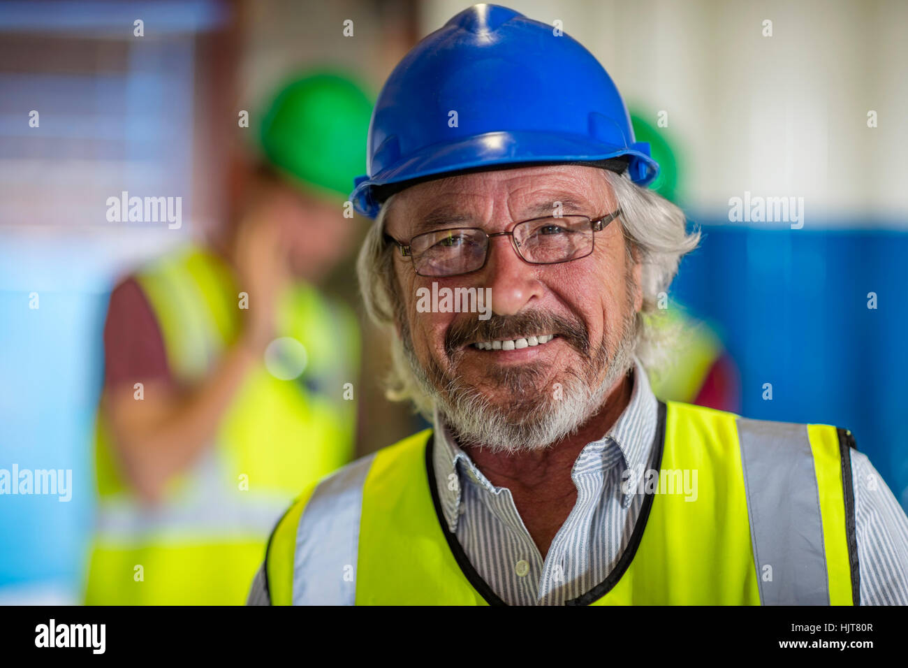 Senior engineer wearing safety helmet, portrait Stock Photo - Alamy