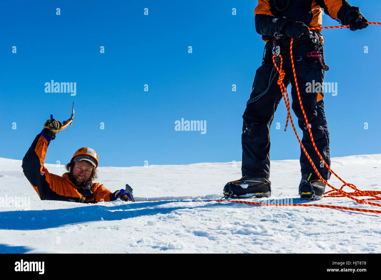 Ice guides entering a crevasse on the slopes of Mount Erebus in ...