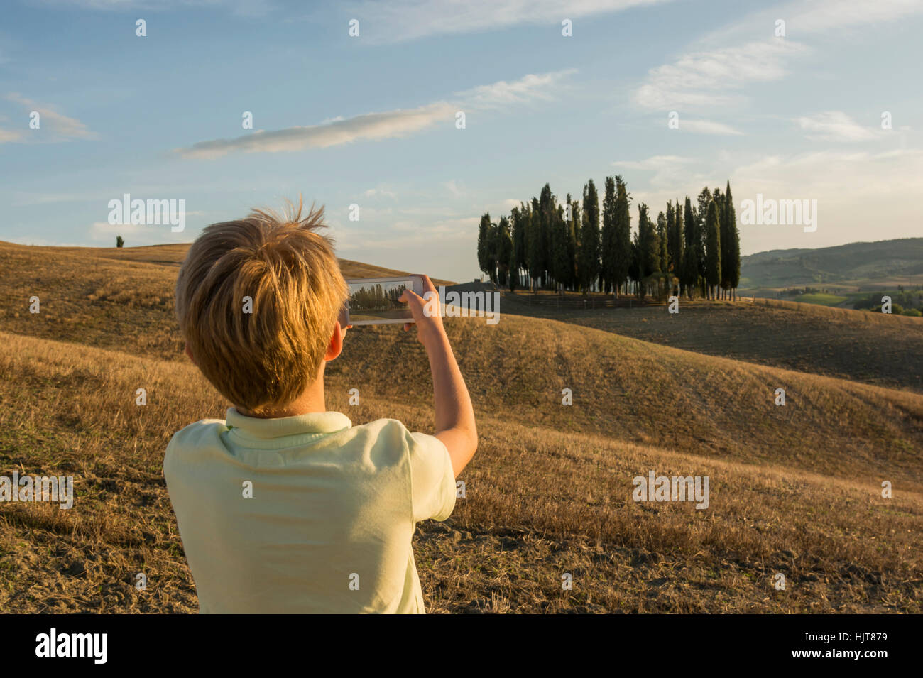 Italy, Tuscany, Boy taking pictures of landscape Stock Photo - Alamy