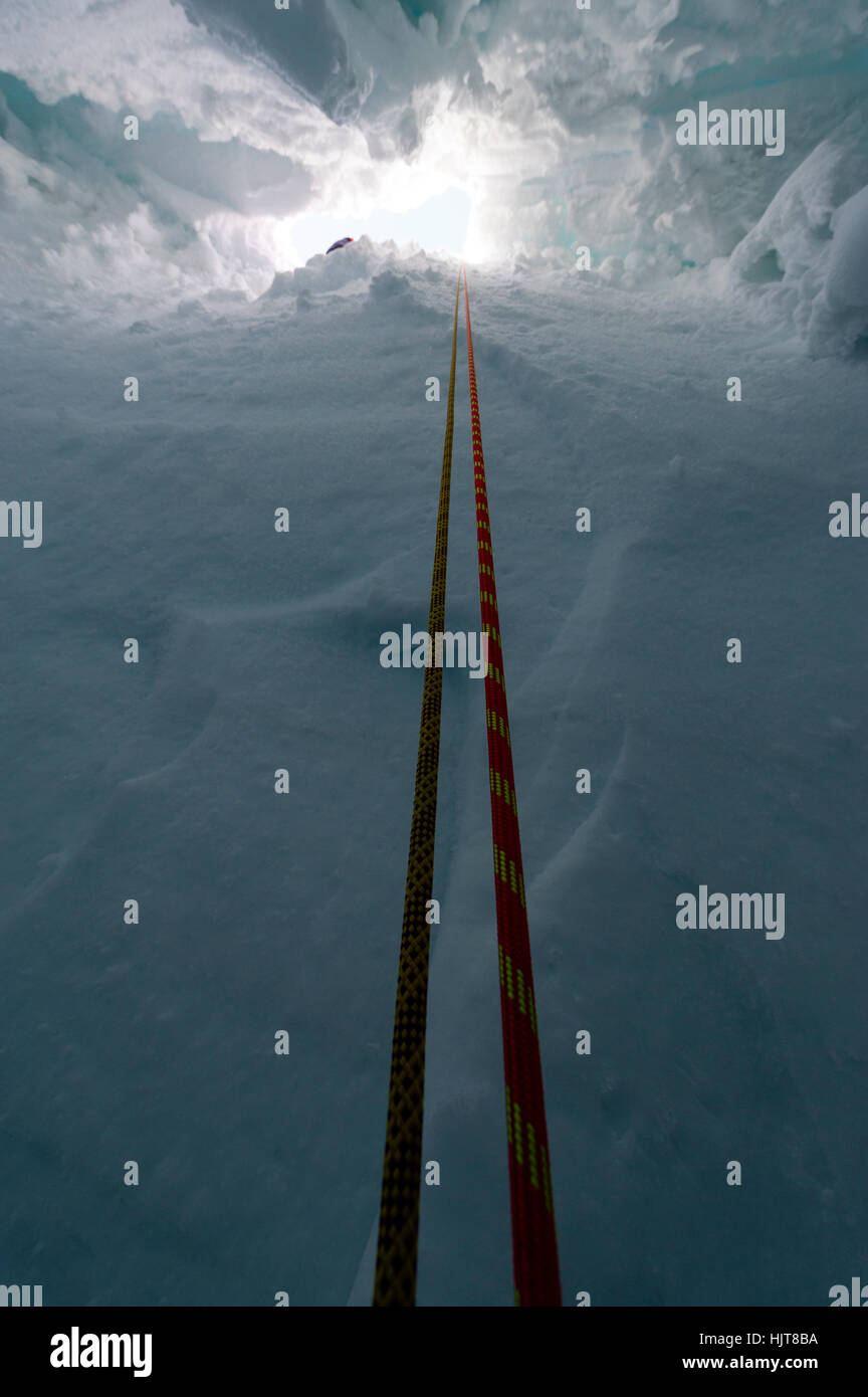 Ropes descending into the entrance of a crevasse on the slopes of Mount ...