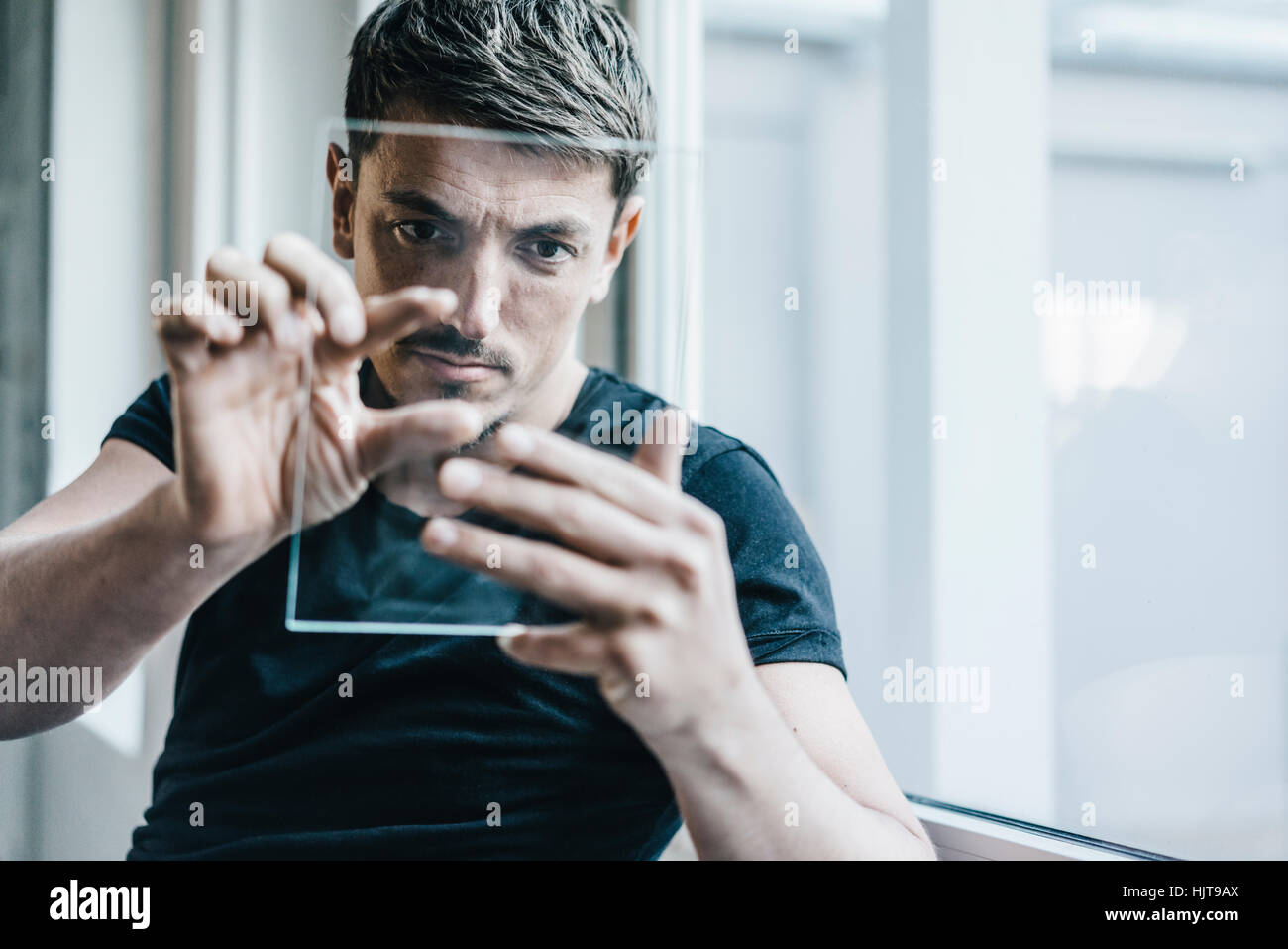 Man using transparent mobile device Stock Photo - Alamy