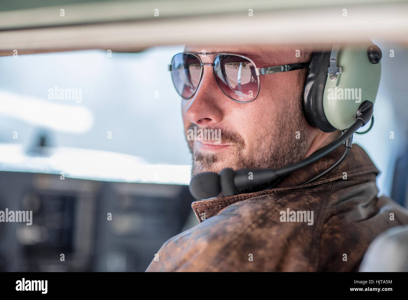 Young pilot sitting in cockpit, portrait Stock Photo - Alamy