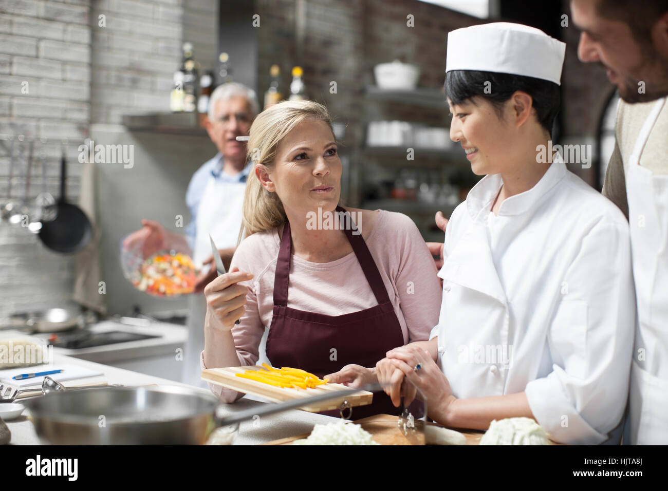 Group of people taking cooking course Stock Photo - Alamy