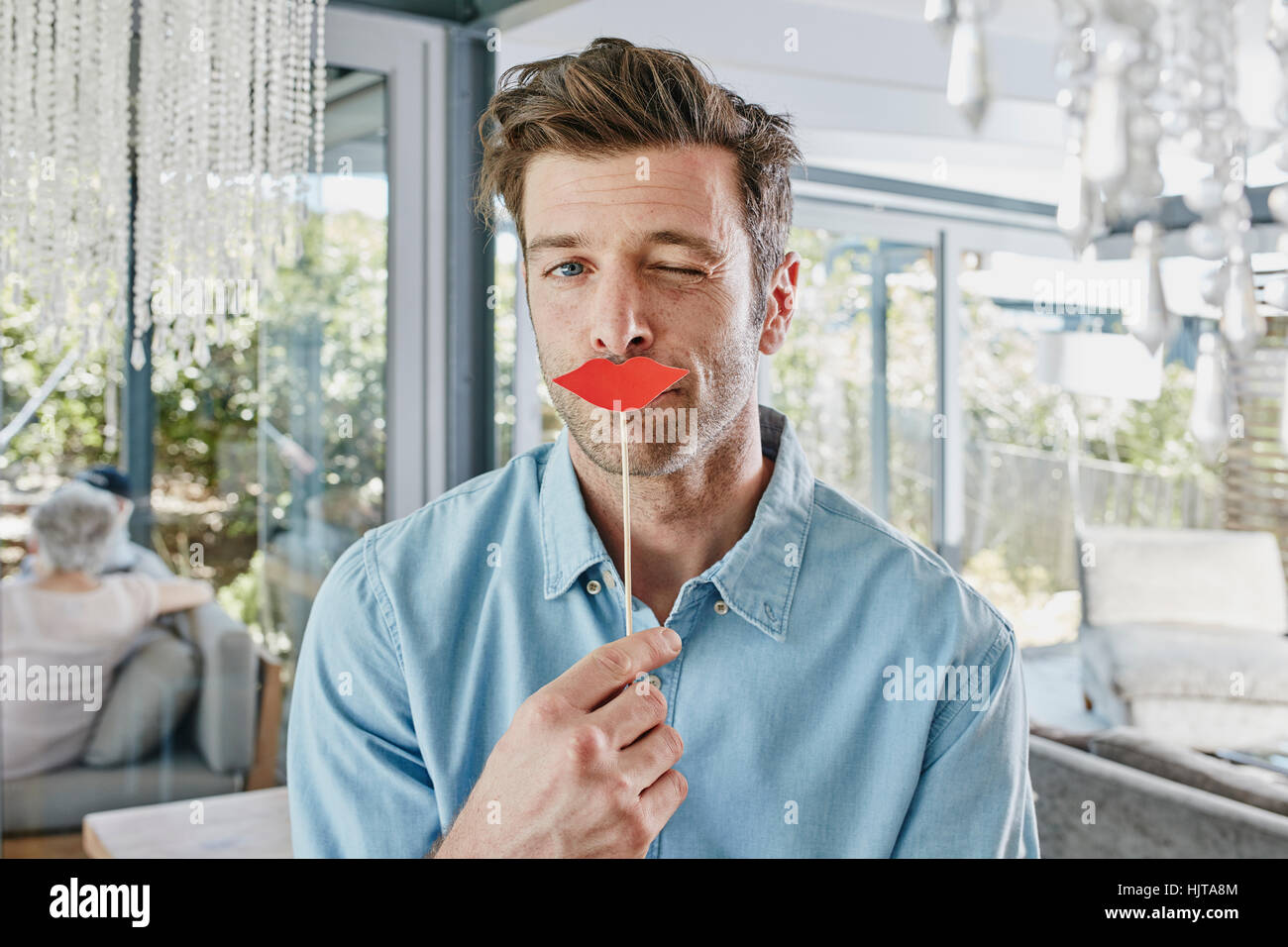 Man holding paper lips in front of his mouth Stock Photo - Alamy