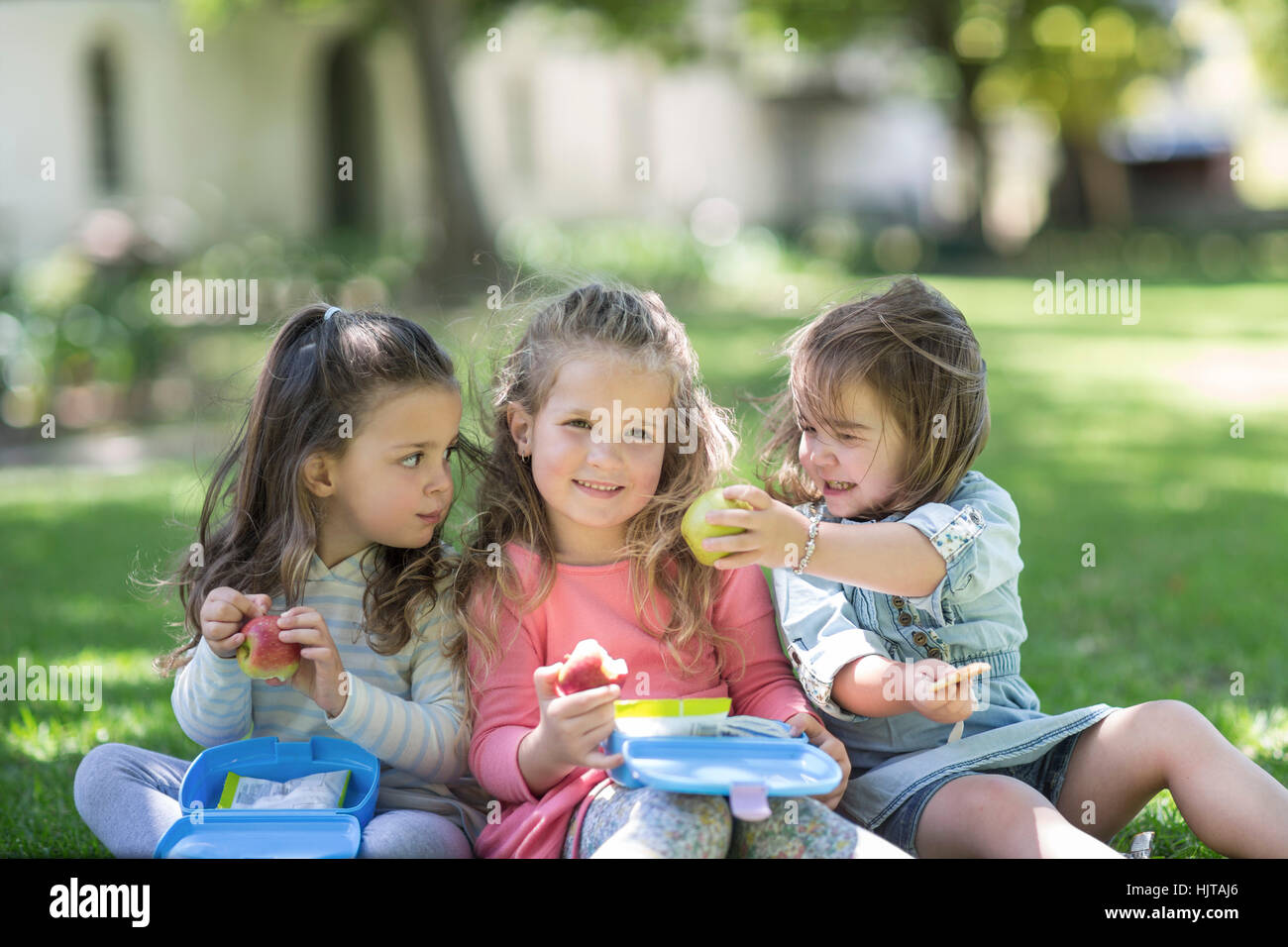 Children sharing snack fruit hi-res stock photography and images - Alamy