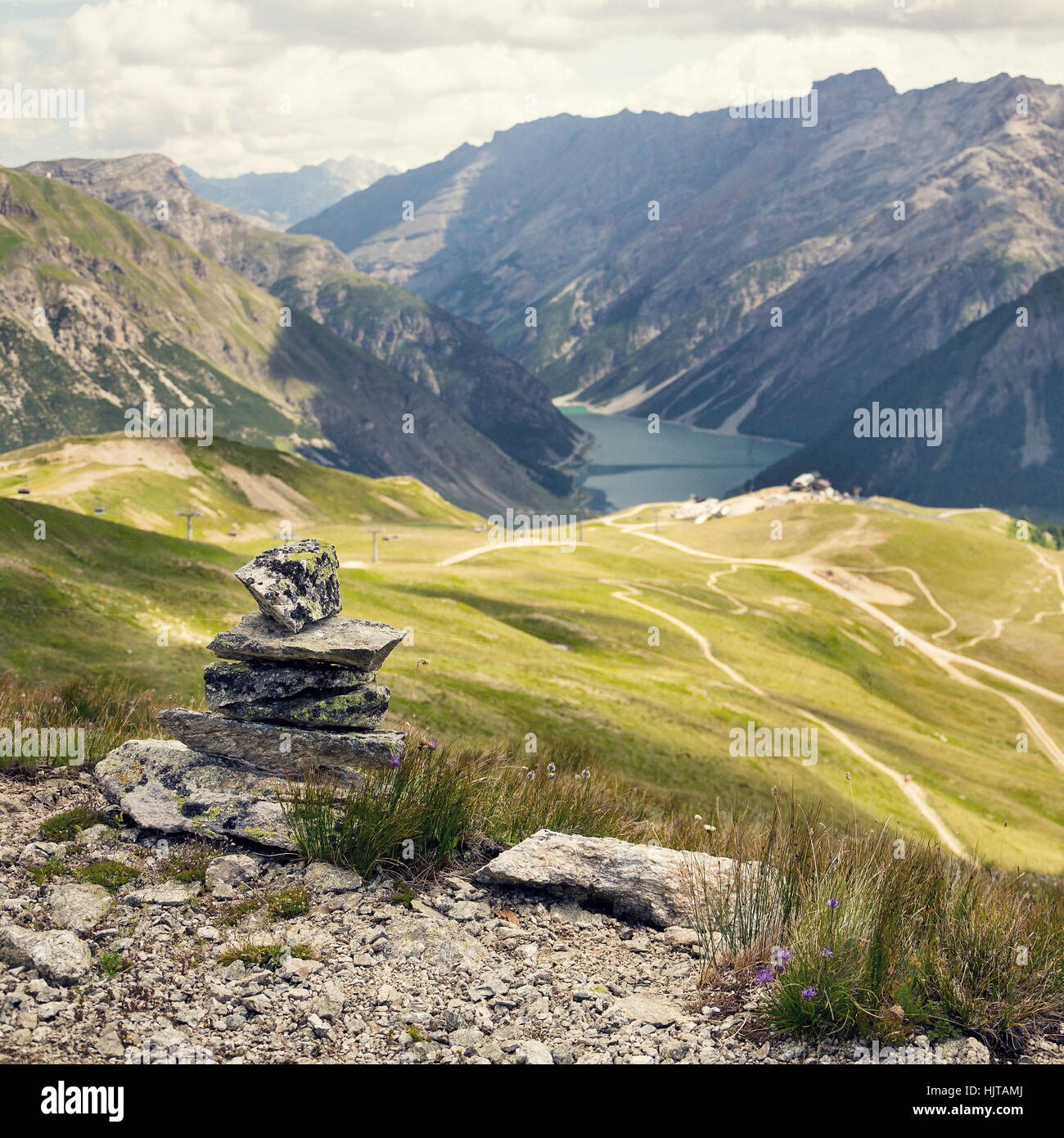 Filtered balanced stone pyramid in with blue water mountain lake Stock ...