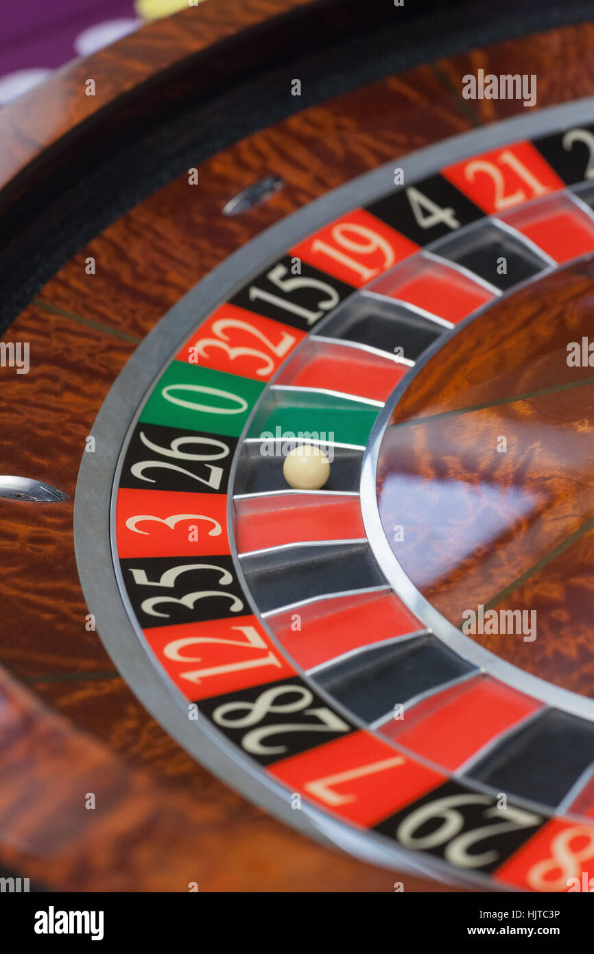 Roulette wheel stopping and ball landing on black 26 Stock Photo - Alamy
