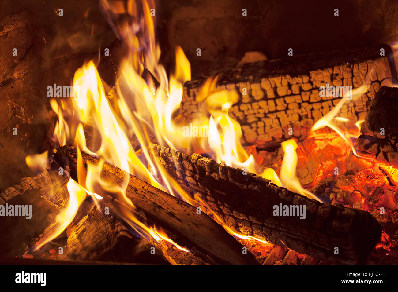 burning wooden logs in the fireplace, note shallow depth of field Stock ...