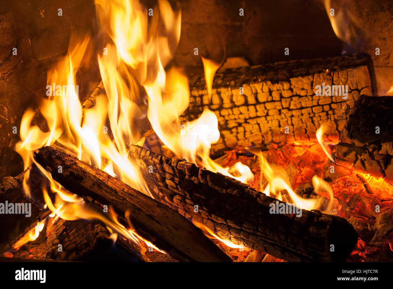 burning wooden logs in the fireplace, note shallow depth of field Stock ...