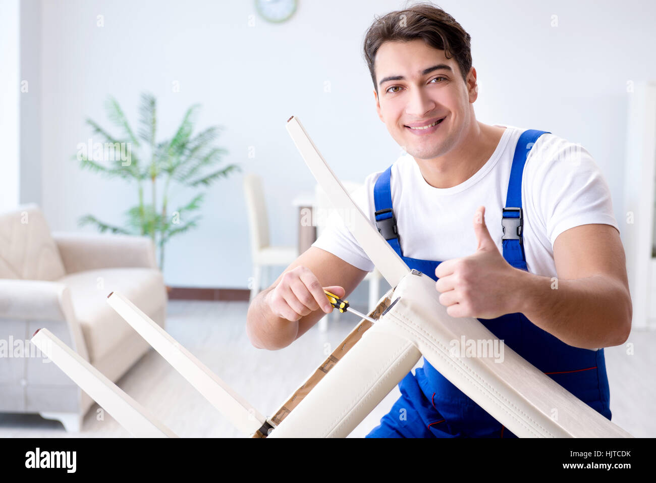 Man repairing chair in the room Stock Photo - Alamy