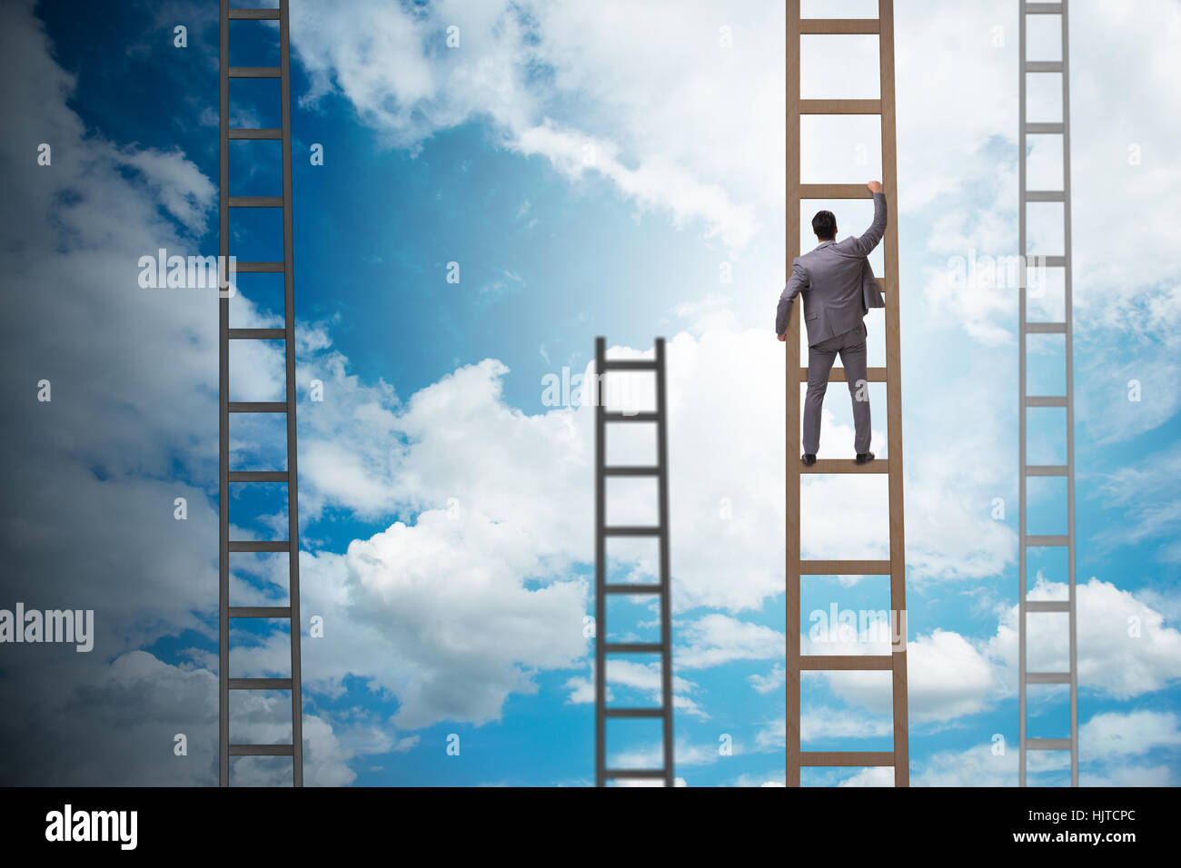 Young businessman climbing career ladder Stock Photo - Alamy