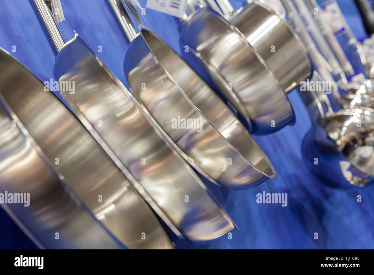 pans and ladles on the blue wall, note shallow depth of field Stock ...