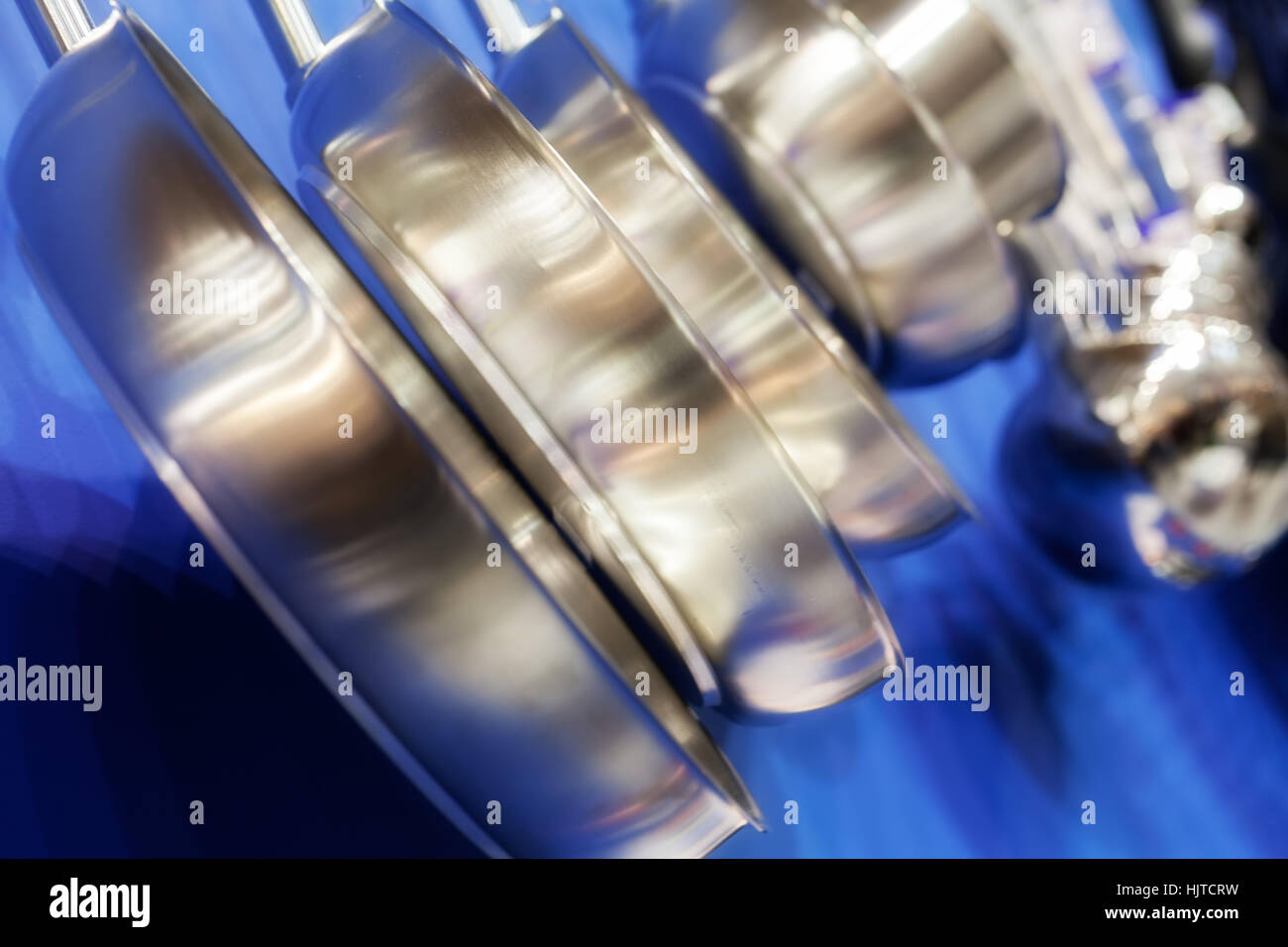 pans and ladles on the blue wall, note shallow depth of field Stock ...