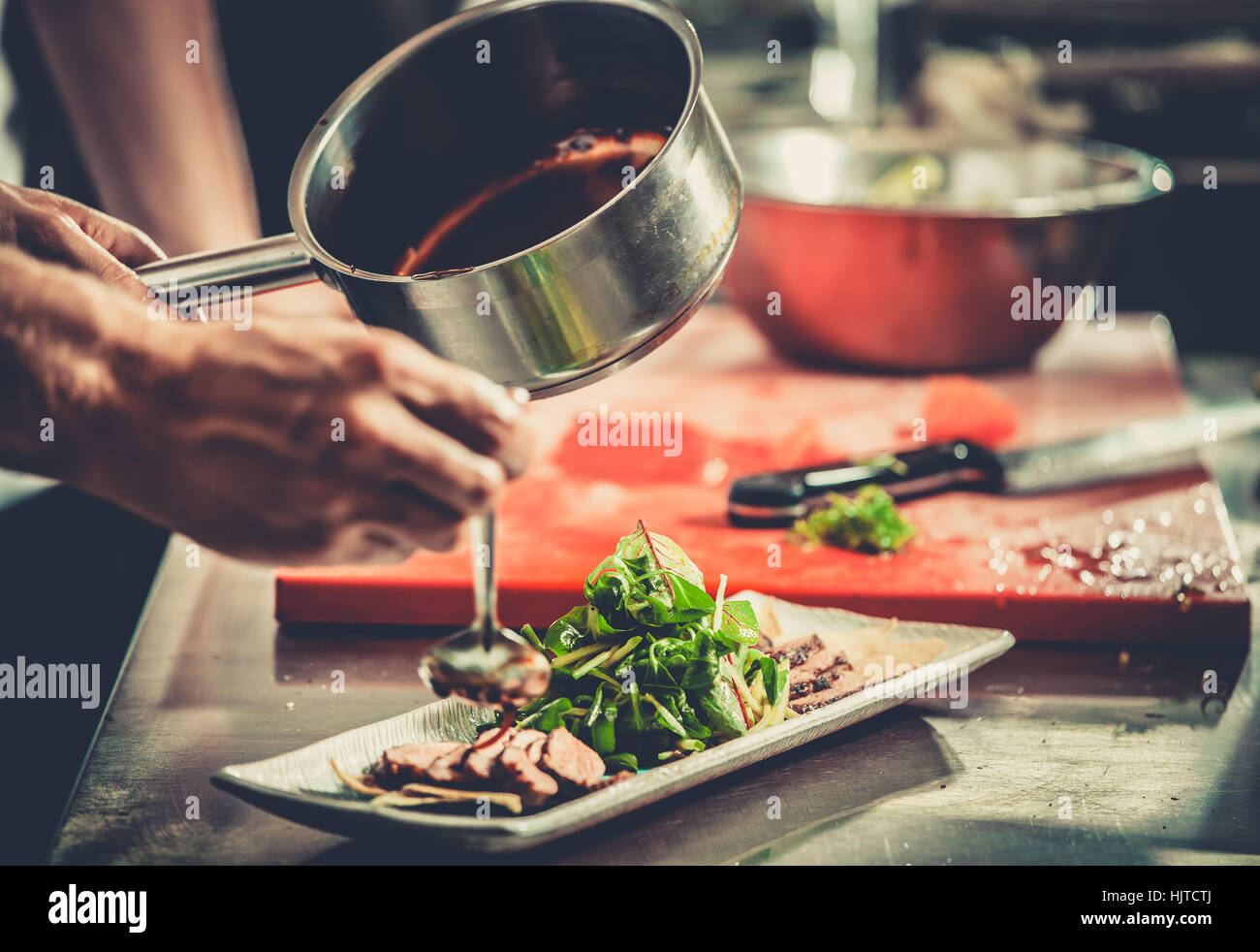 Busy chef at work in the restaurant kitchen Stock Photo - Alamy